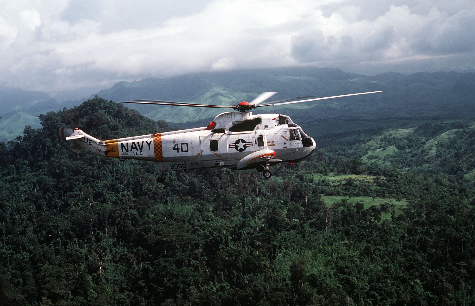 An air-to-air right side view of an SH-3A Sea King helicopter from ...