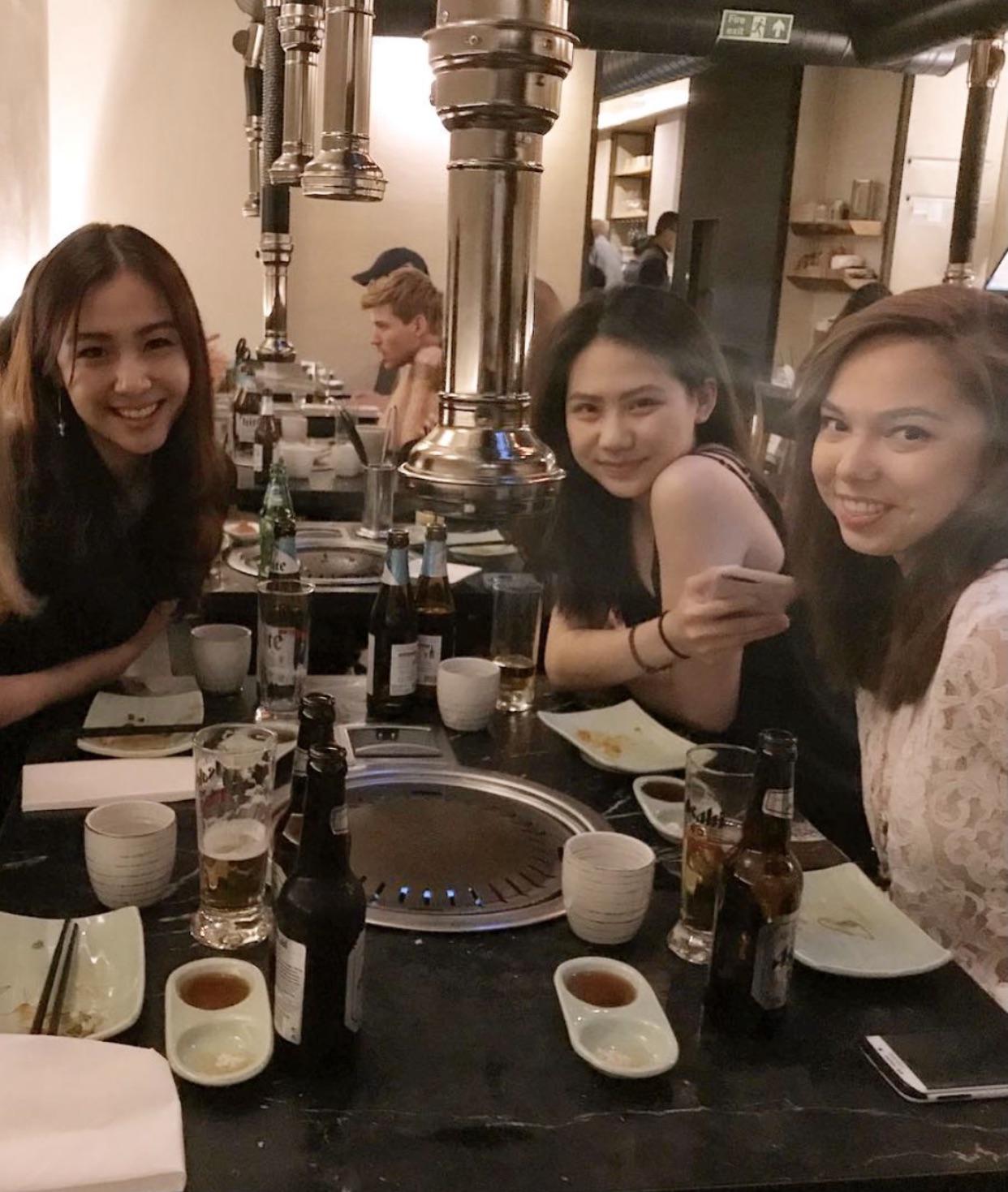 Asian friends in a restaurant | Scrolller