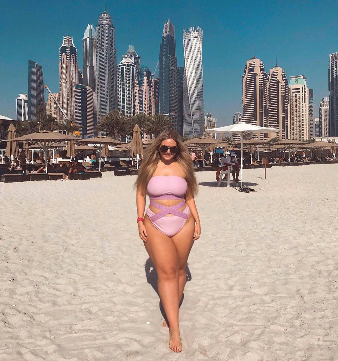 Amazing curves filling out her one-piece | Scrolller