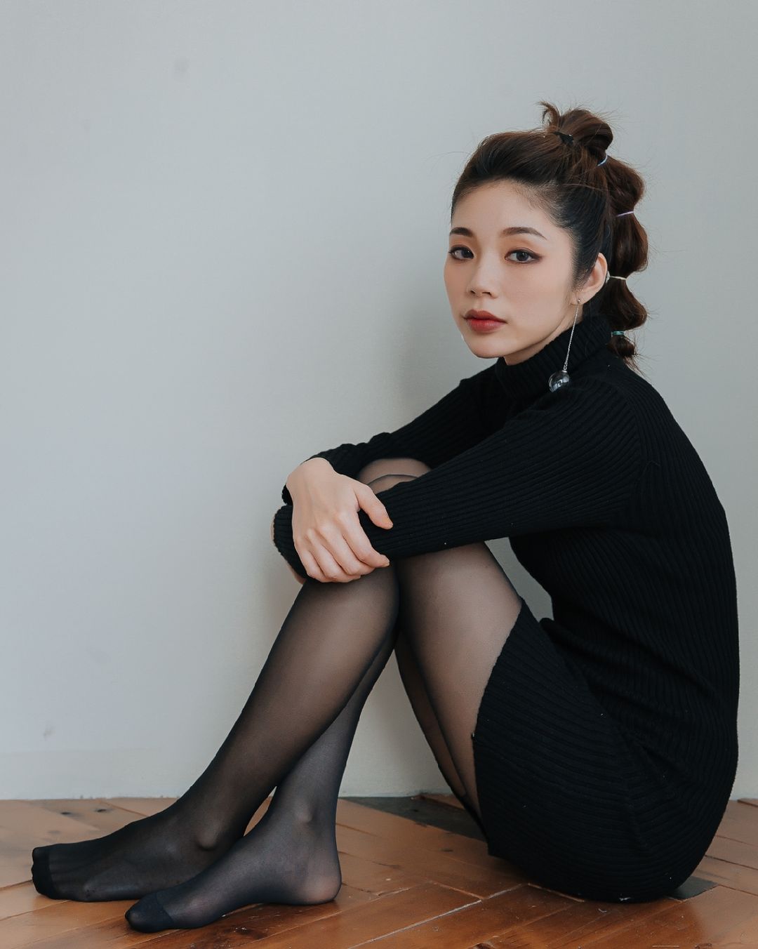 Black sweater dress and feet in black nylons | Scrolller