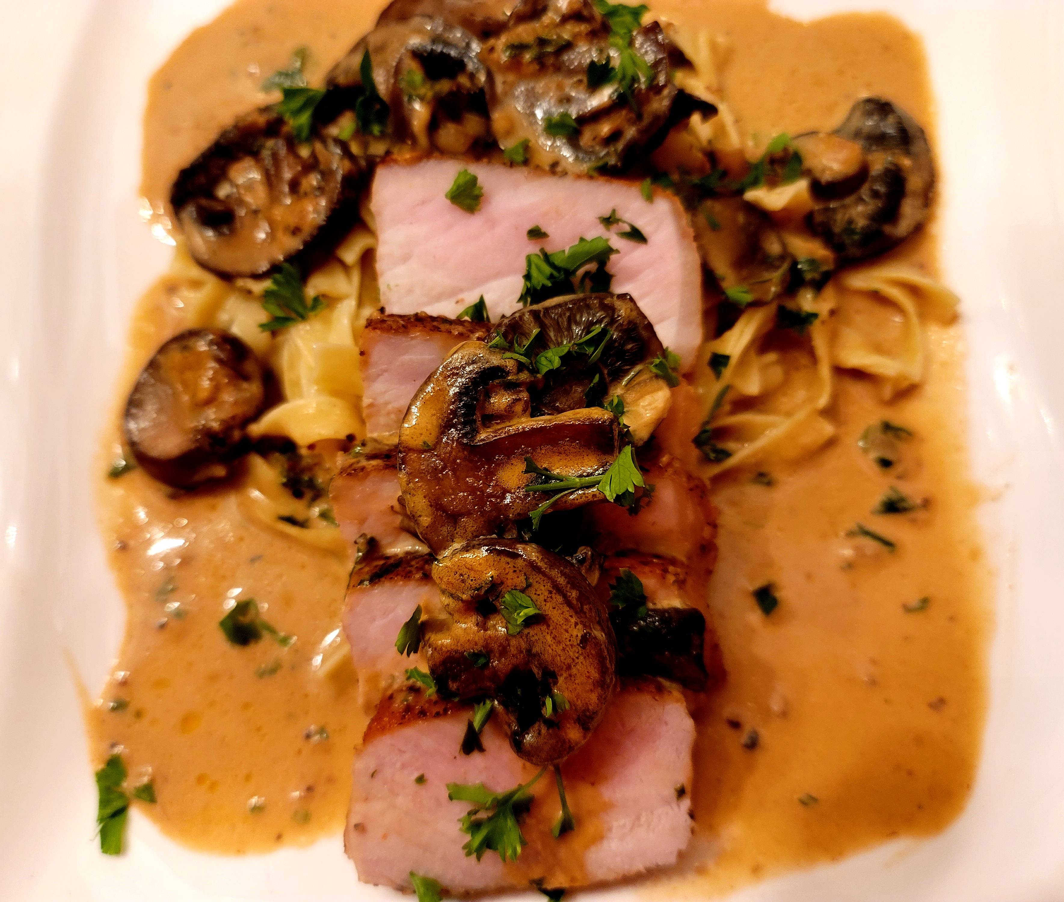Boneless pork chops in a miso and mushroom cream sauce. | Scrolller