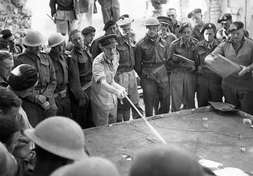 British brigadier general illustrating maneuvers to tank commanders for the operation to relieve ...