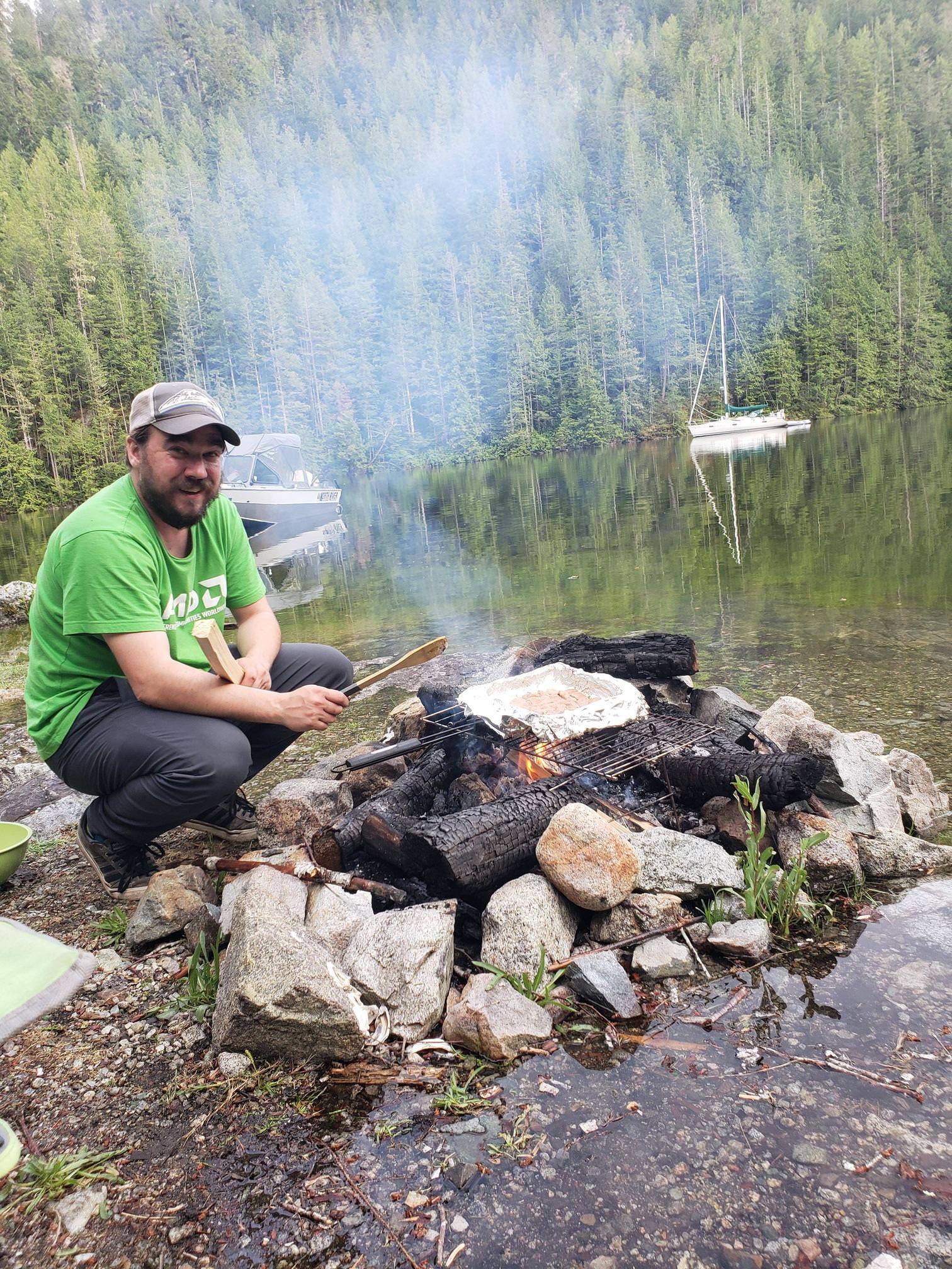 Campfire cooking in the water. Steak and potatoes | Scrolller