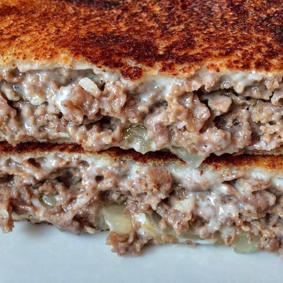 Cheesesteak melt with Cooper sharp American Cheese and fried onions. | Scrolller