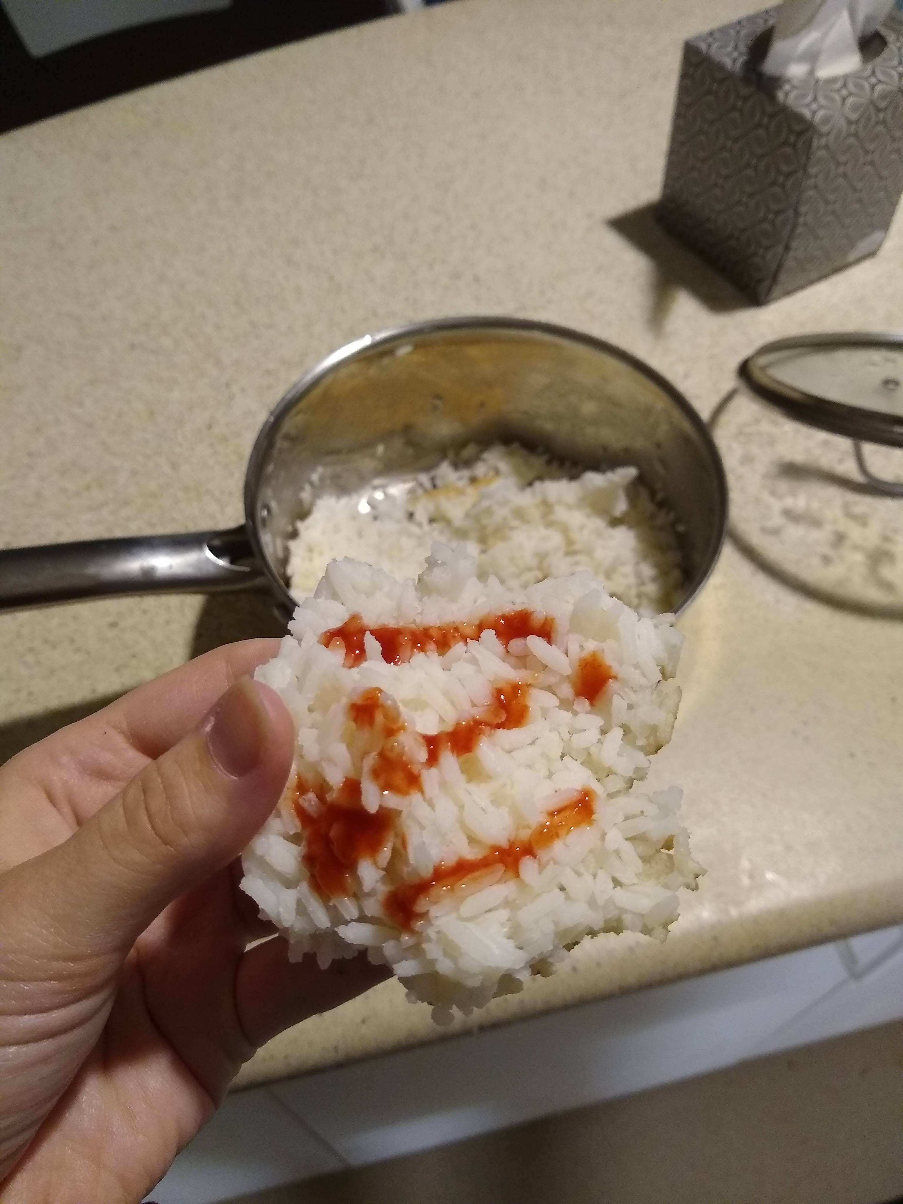 Cold slab of leftover rice that scorched to the bottom of the pan, garnished with sriracha ...