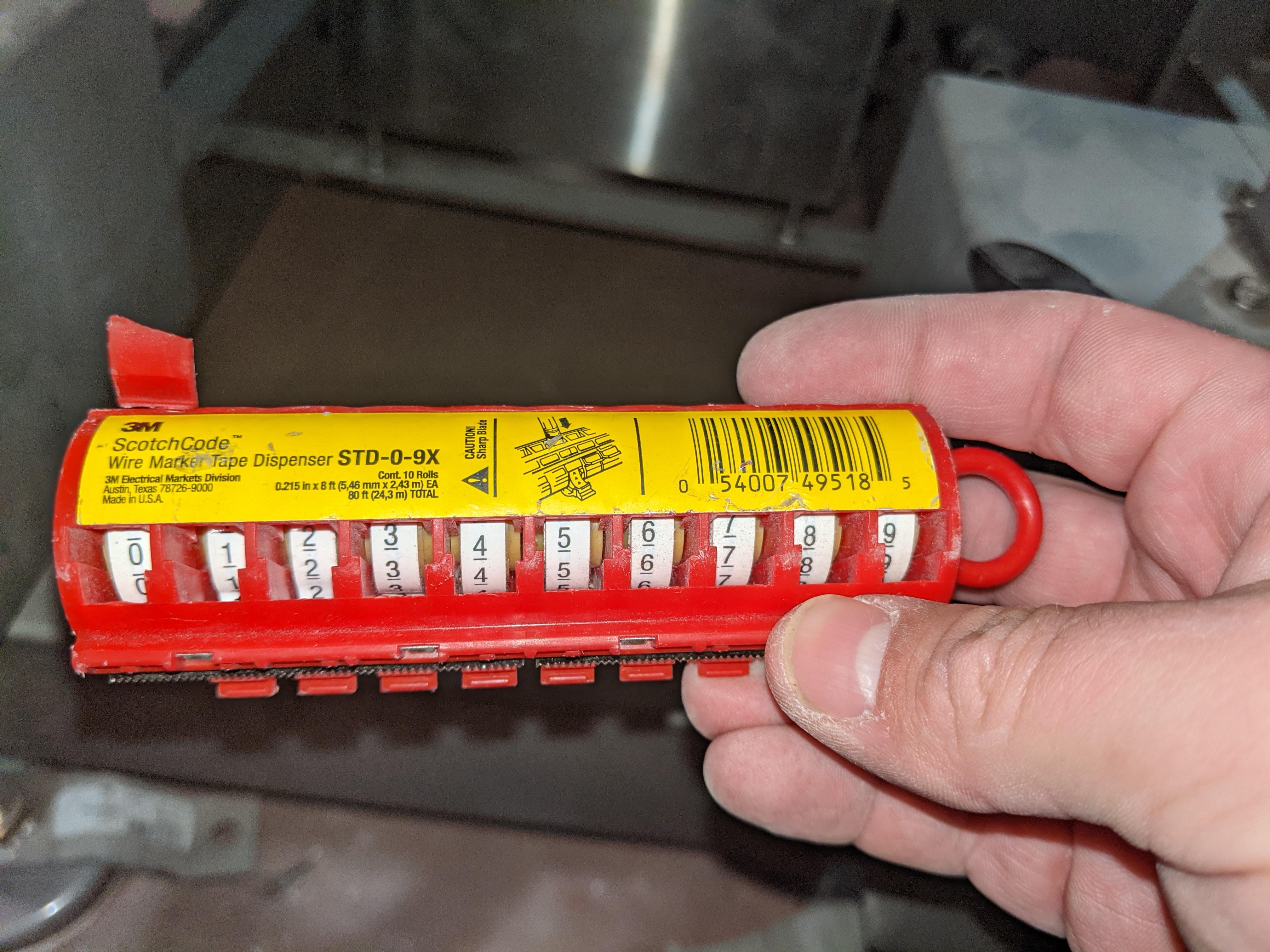 Dispenser for labeling wires by number. | Scrolller