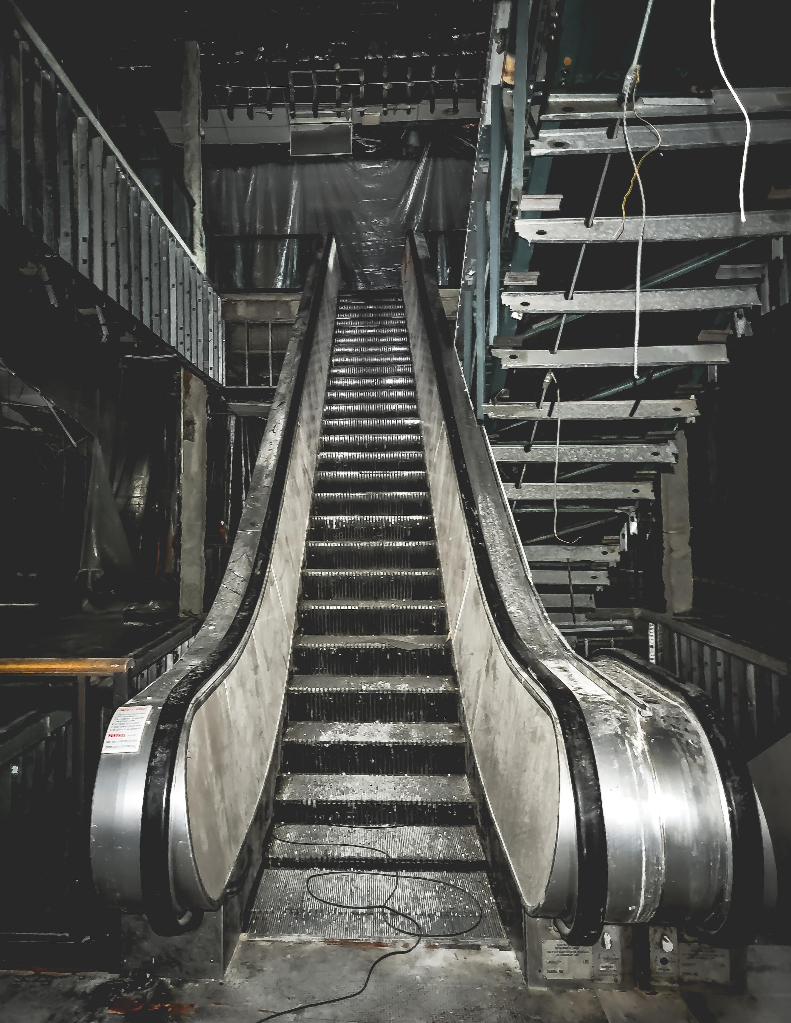 Escalator inside an abandoned mall, Sears department store. | Scrolller