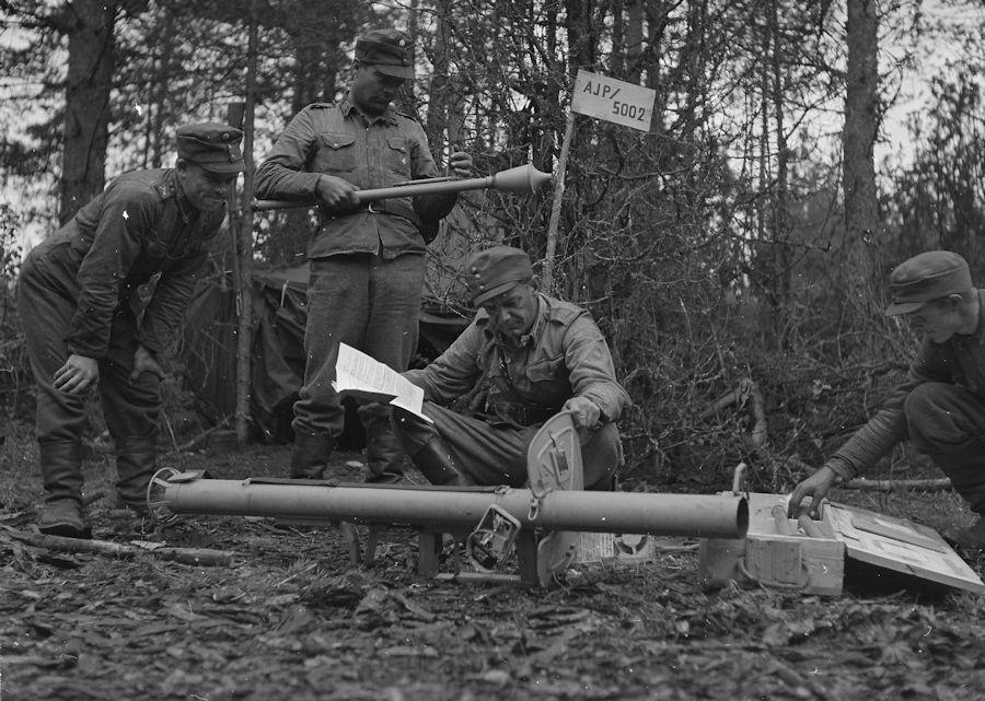 Finnish soldiers reading Panzerschreck manual just delivered from Germany (1944) | Scrolller
