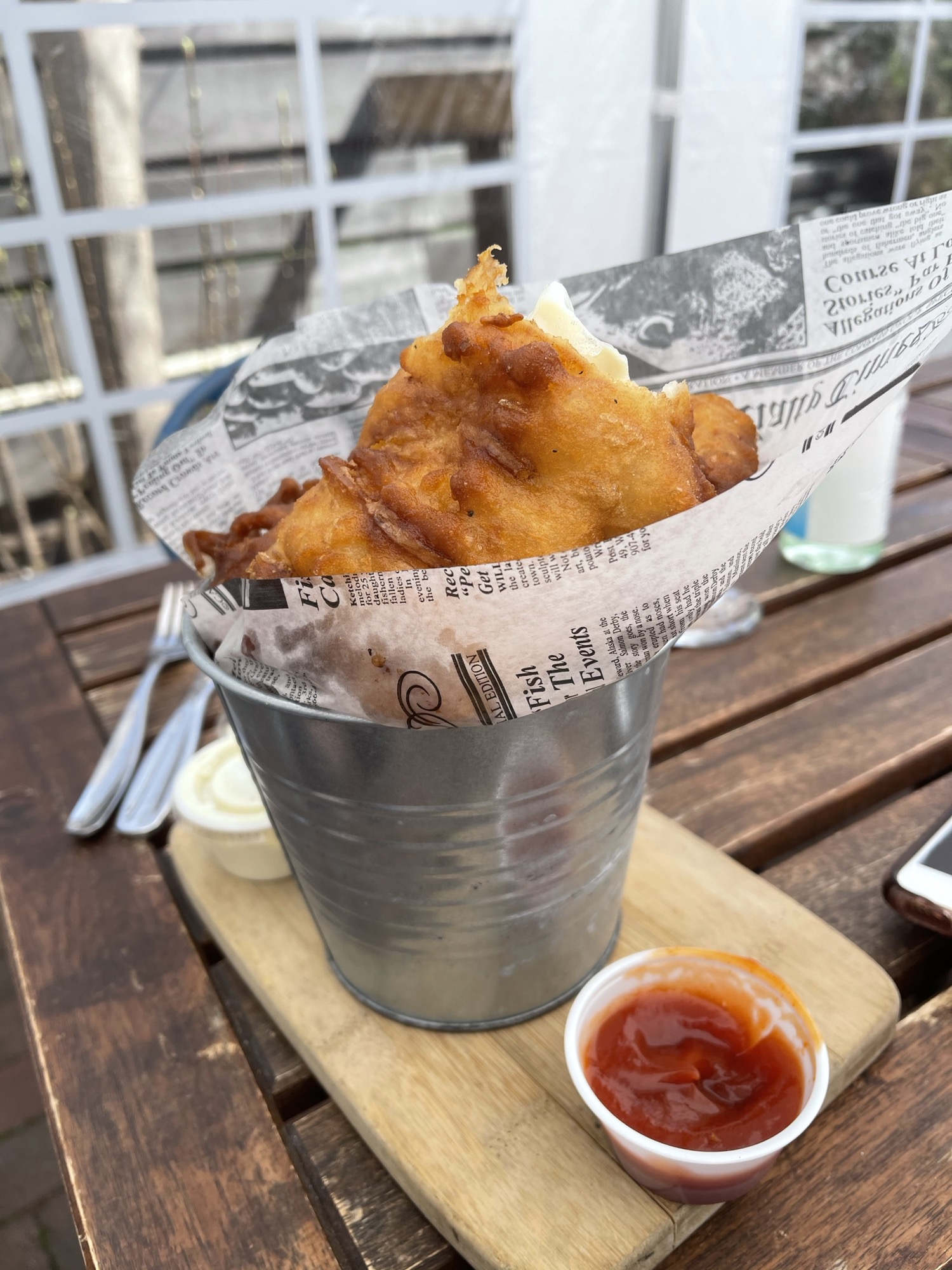 Fish and chips in a bucket on a plank | Scrolller