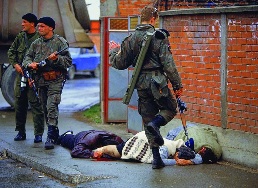 [History] Serbian paramilitary kicking a woman’s body during ethnic cleansing in Bosnia, 1992 ...