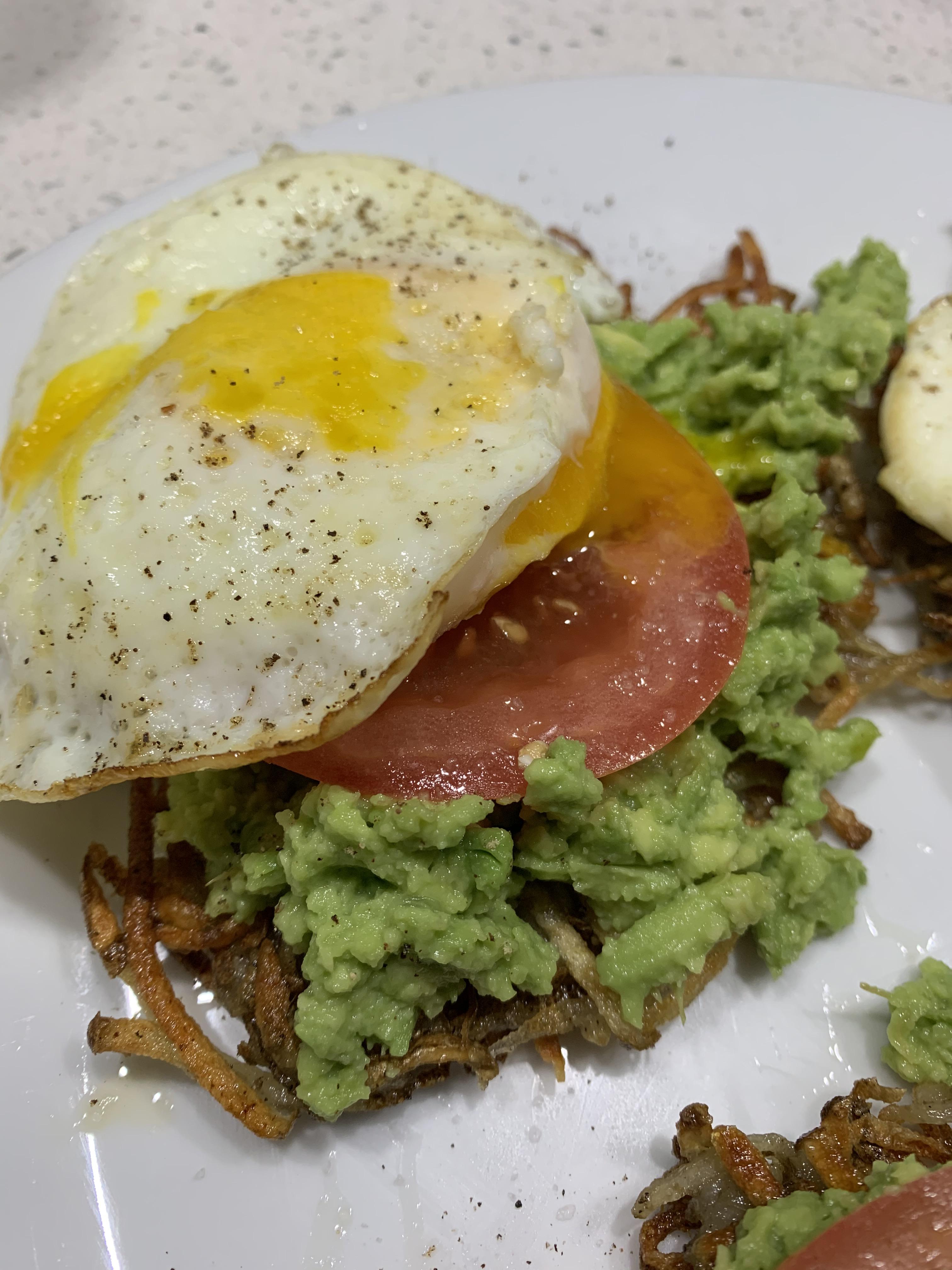 Homemade latkes topped with avocado, tomato and a fried egg | Scrolller