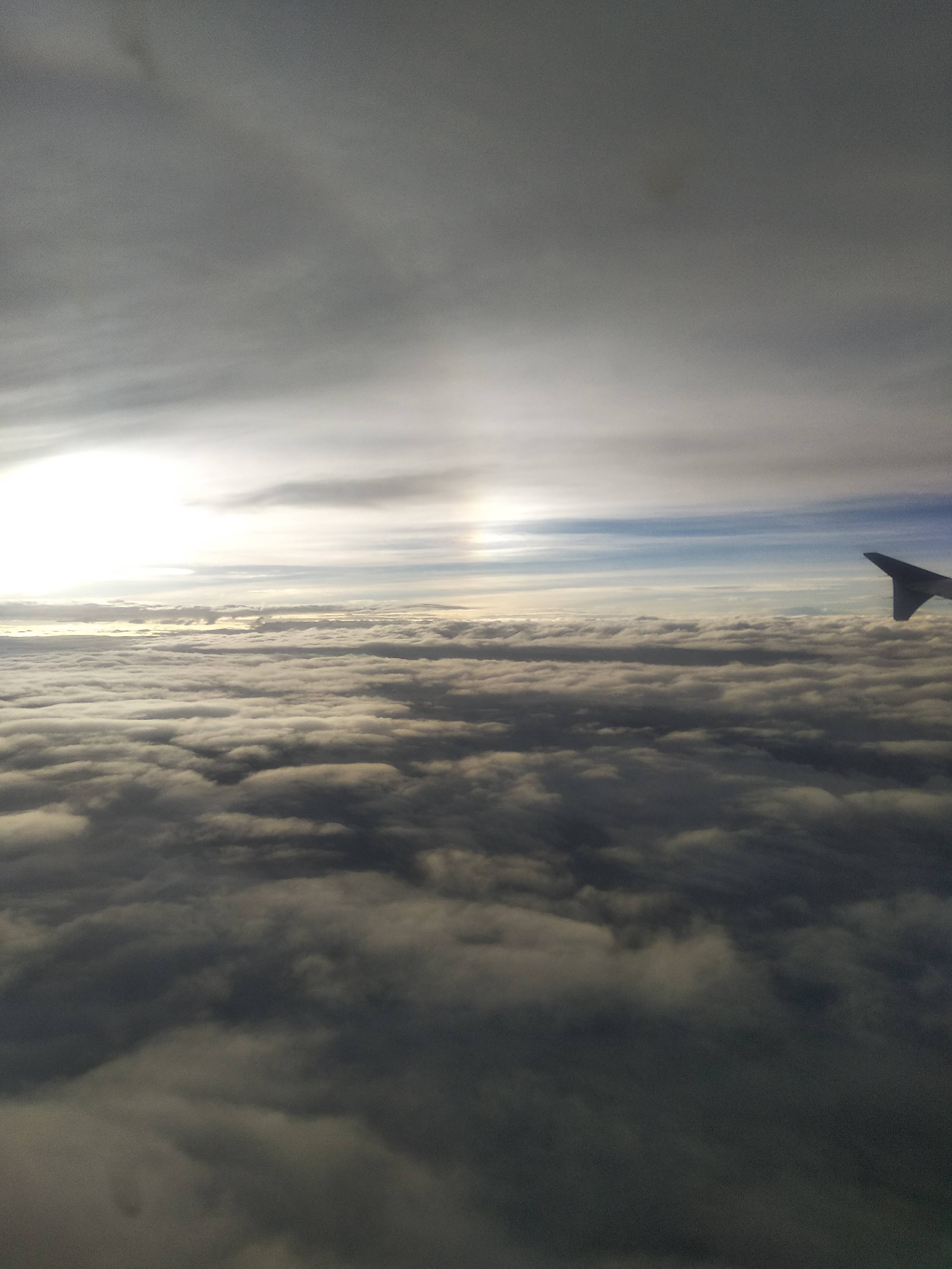 Is this a sundog? Took this photo from a morning flight over monsoon clouds | Scrolller
