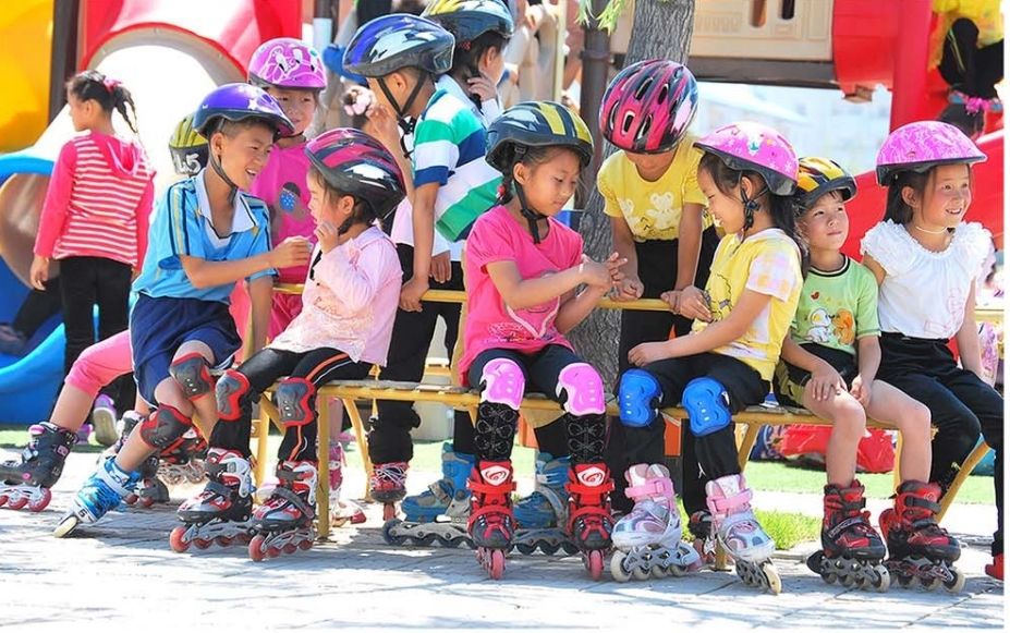 Kids wearing rollerblades in Hoeryong City, North Hamgyong Province | Scrolller
