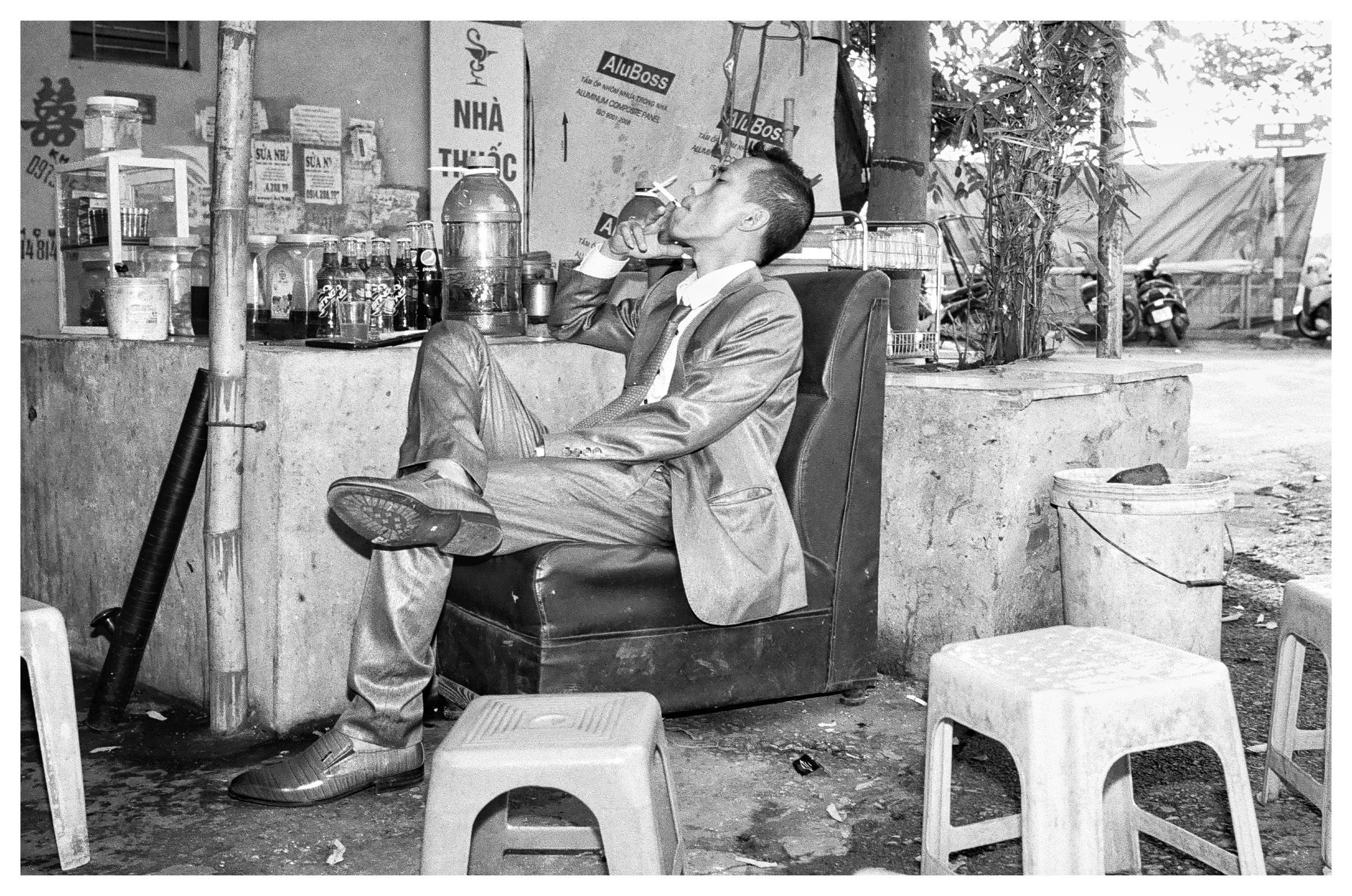 Man Smoking In Hanoi / Contax T3 / Ilford Pan 400 | Scrolller
