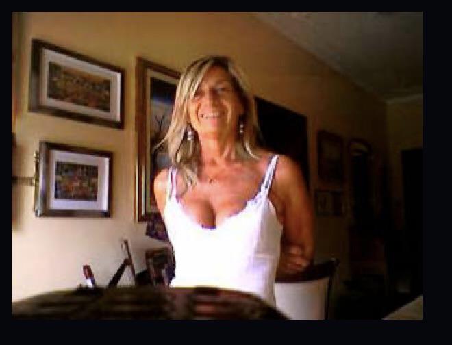 Mature woman. Arms crossed behind back | Scrolller