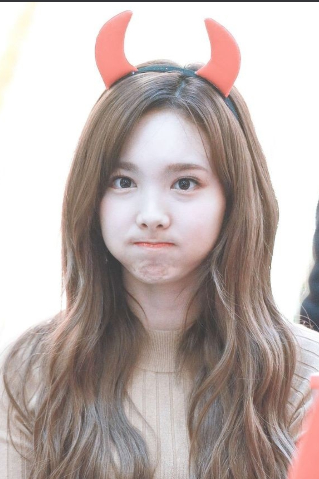 Nayeon - devil horns headband, beige sweater, puffed cheeks | Scrolller
