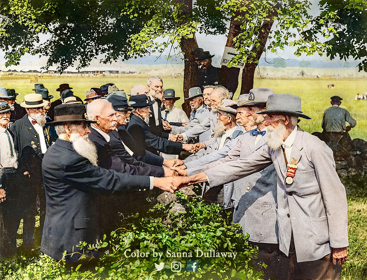Union Blue and Confederate Gray veterans shaking hands at Gettysburg reunion in the year 1913 ...