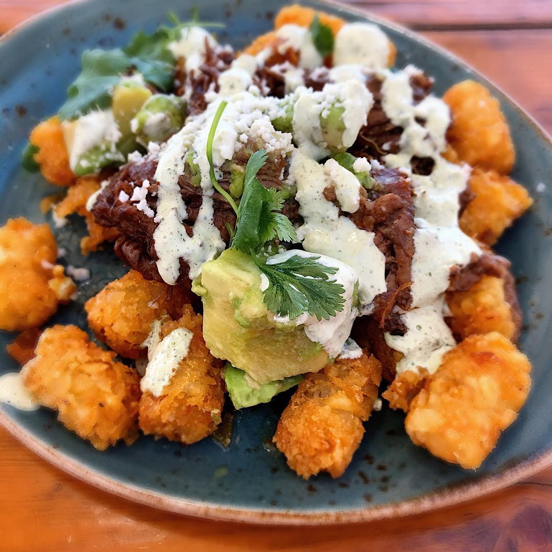 Short-rib tater tots topped with cotija, avocado and sour cream [1080 x 1080] | Scrolller