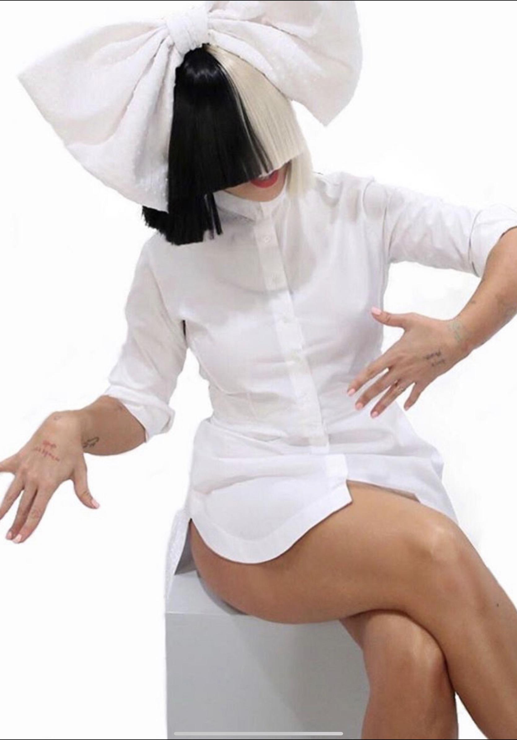 Sia in a drsss so short her bare ass in on the chair. | Scrolller