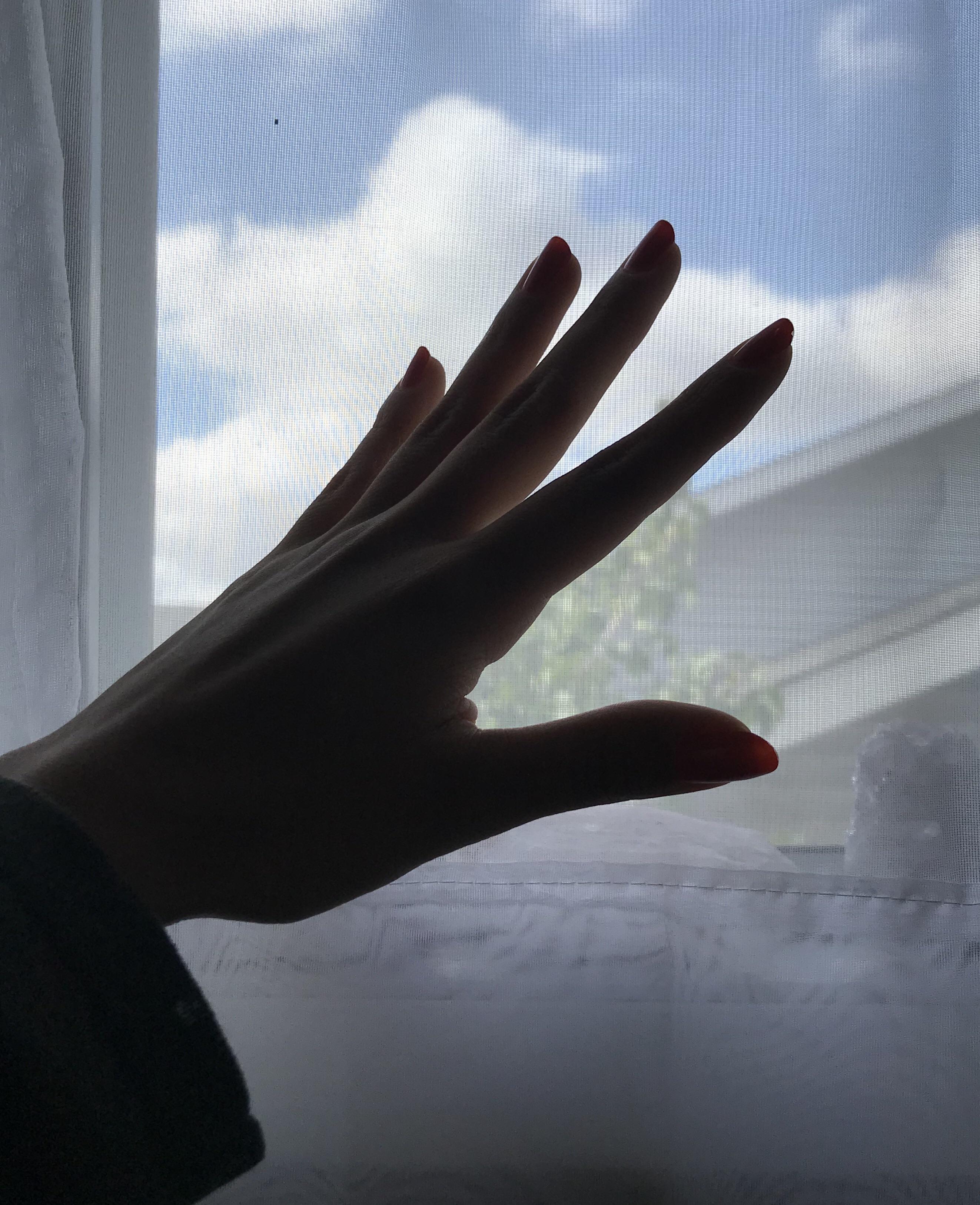 silhouette hand and some cute clouds | Scrolller