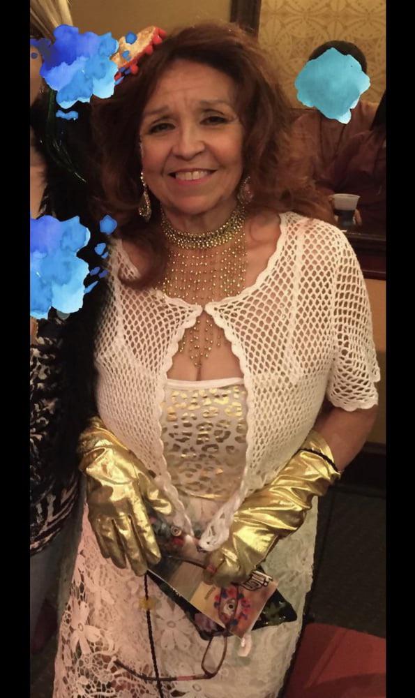 Teasing with that low cut and smile. | Scrolller