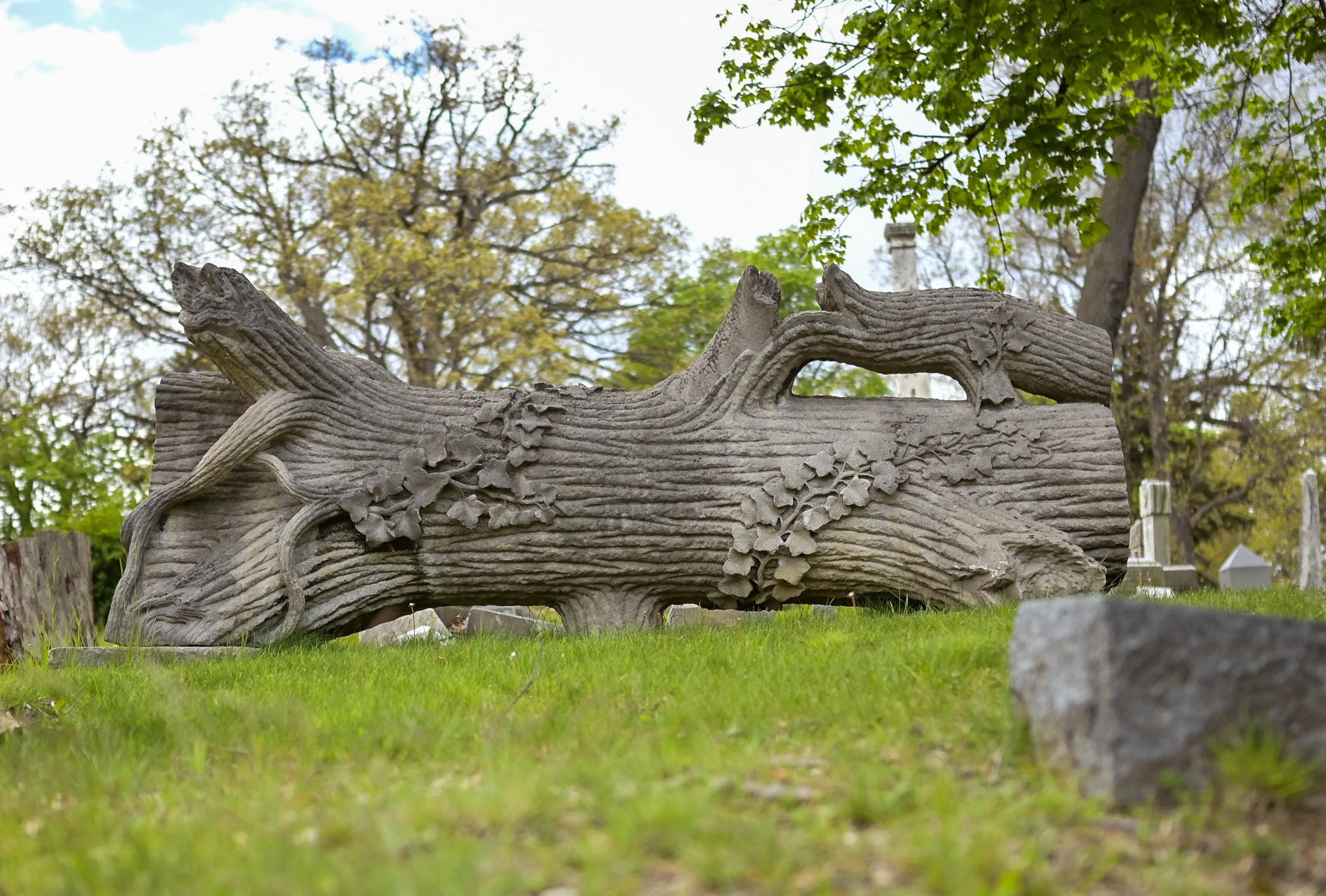 This grave marker shaped as a tree trunk. | Scrolller