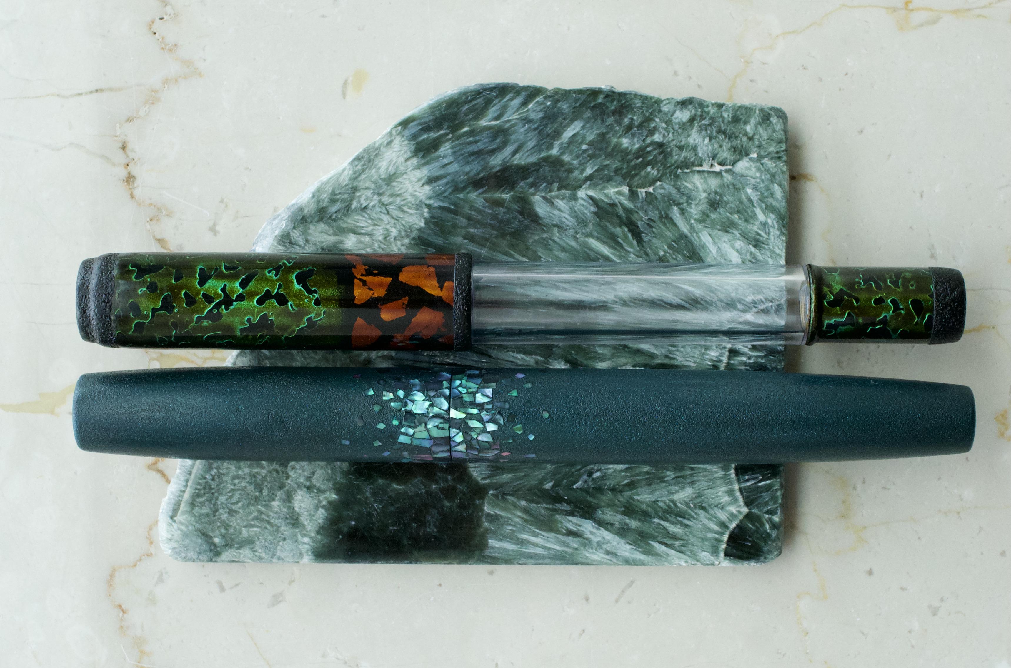 Two Bokumondoh Urushi pens on a slab of Seraphinite | Scrolller