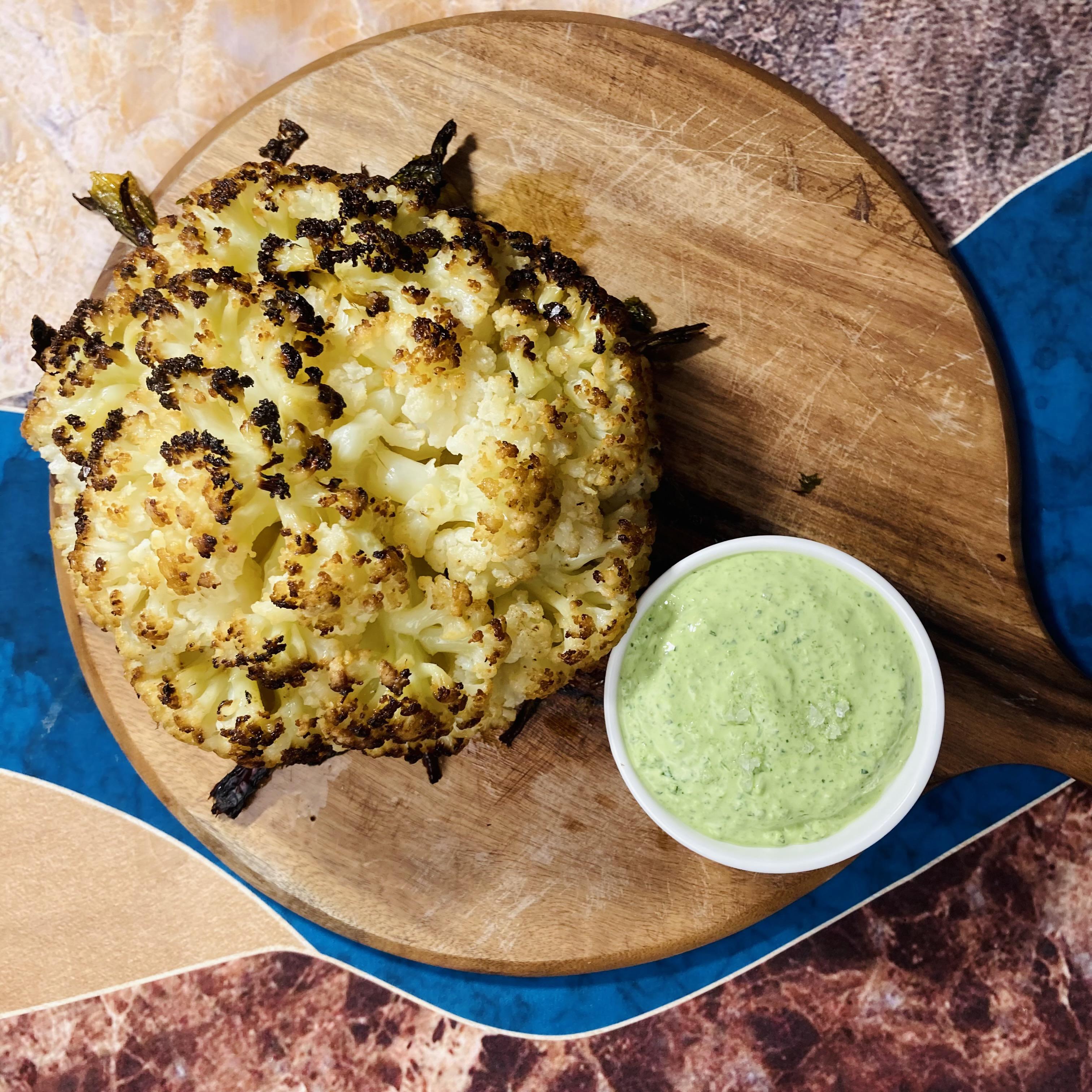 Whole roasted Cauliflower with a green tahini sauce | Scrolller