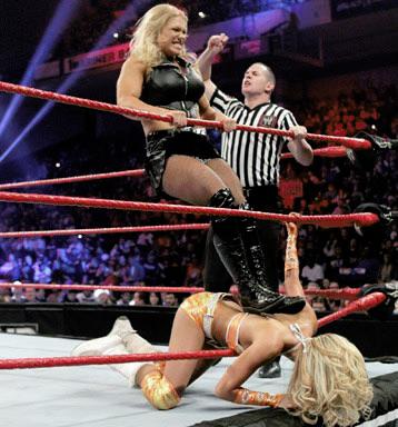 Beth Phoenix standing on Kelly Kelly and putting her weight on her | Scrolller