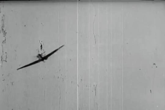 Early model Supermarine Spitfire taking cannon fire from a Messerschmitt Bf 109 at close range ...