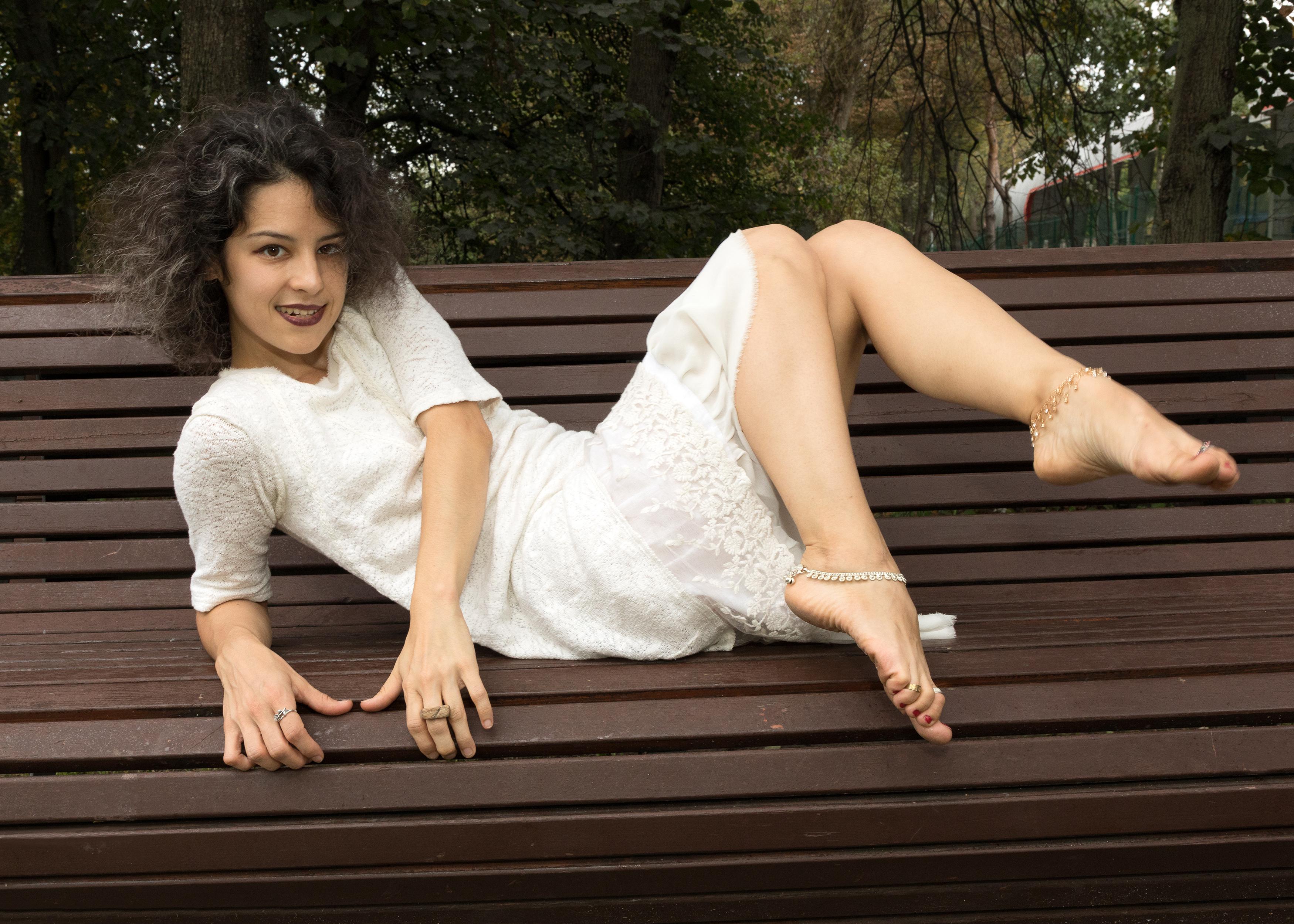 Girl in white on a park bench | Scrolller