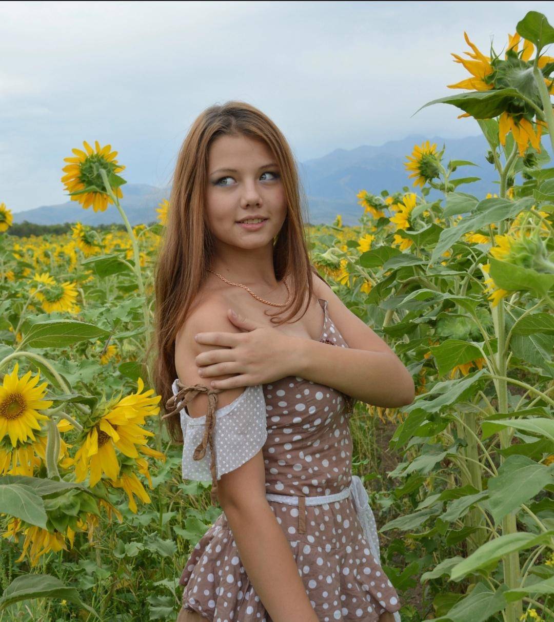 kleofia in sunflower field | Scrolller