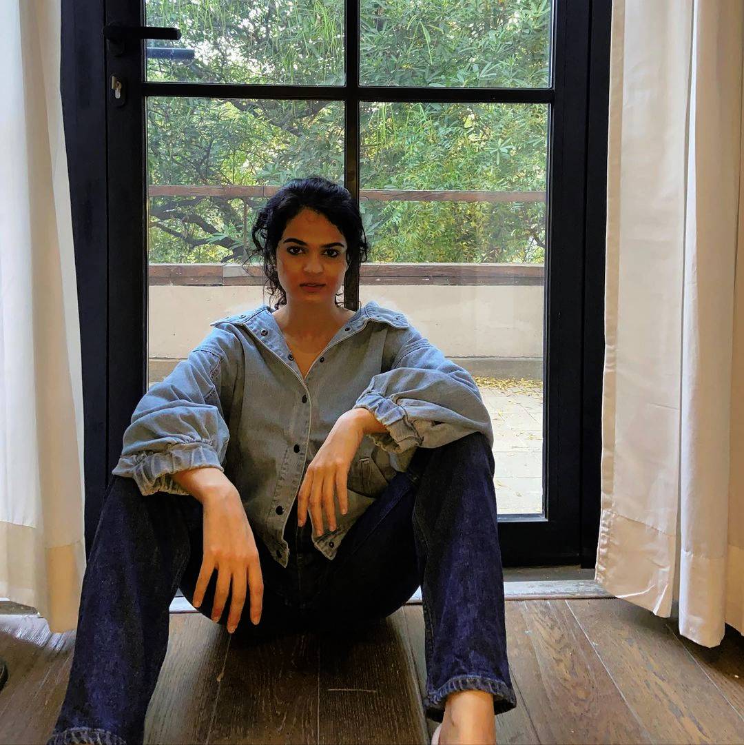 Tania Sachdev waiting on the floor having undone a few buttons already | Scrolller