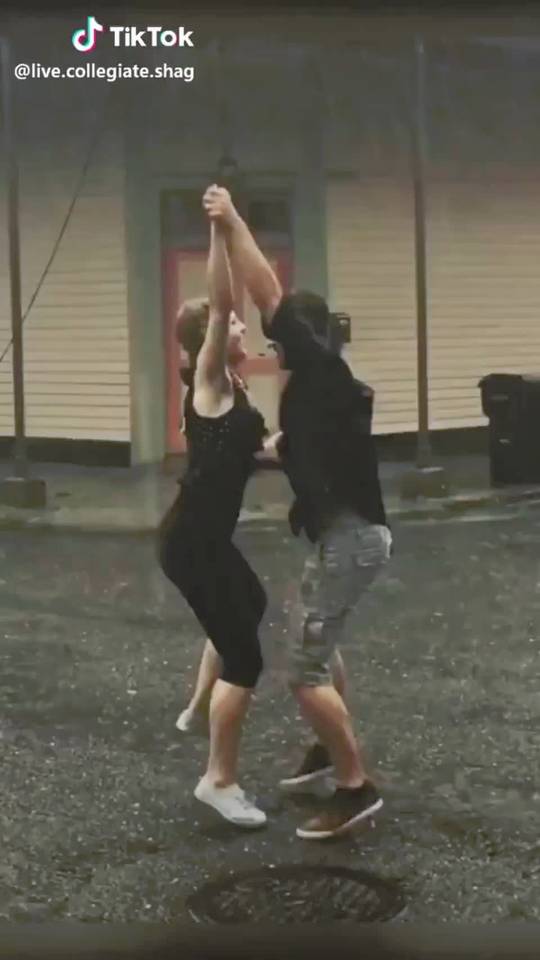 This couple dancing in the rain. | Scrolller