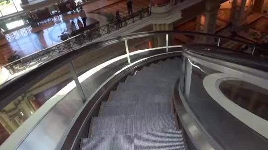 A curved escalator. | Scrolller