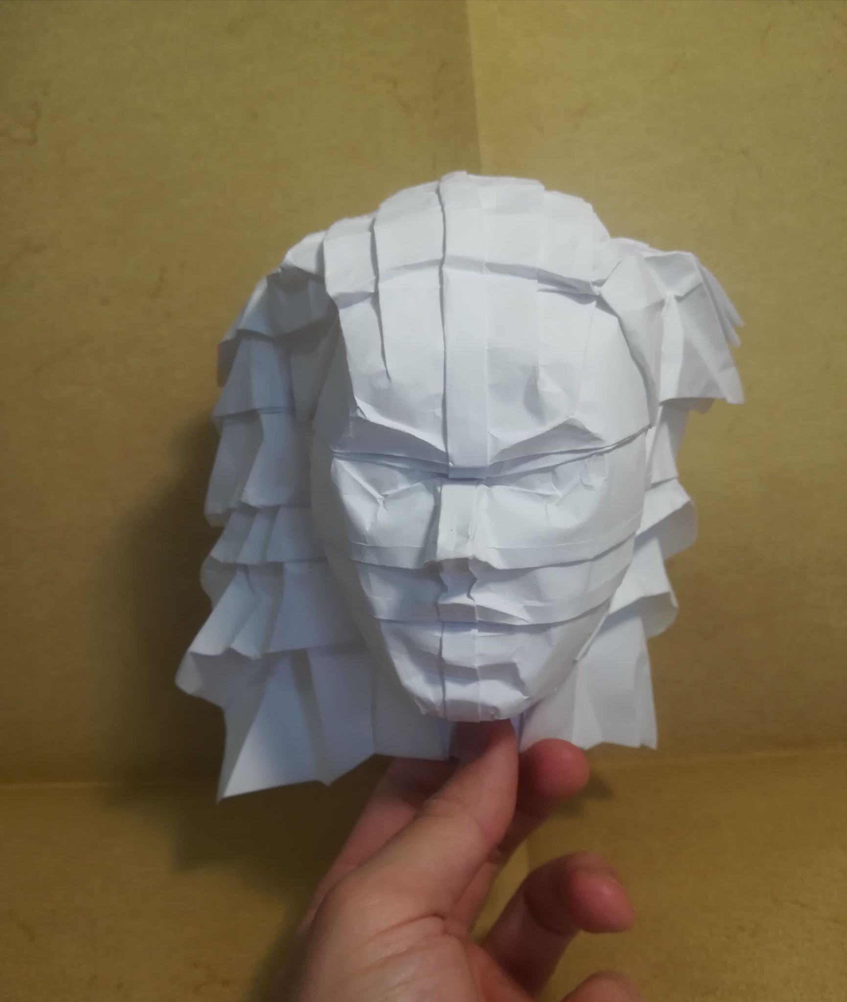 An origami fully detailed human face folded from a rectangle of paper | Scrolller