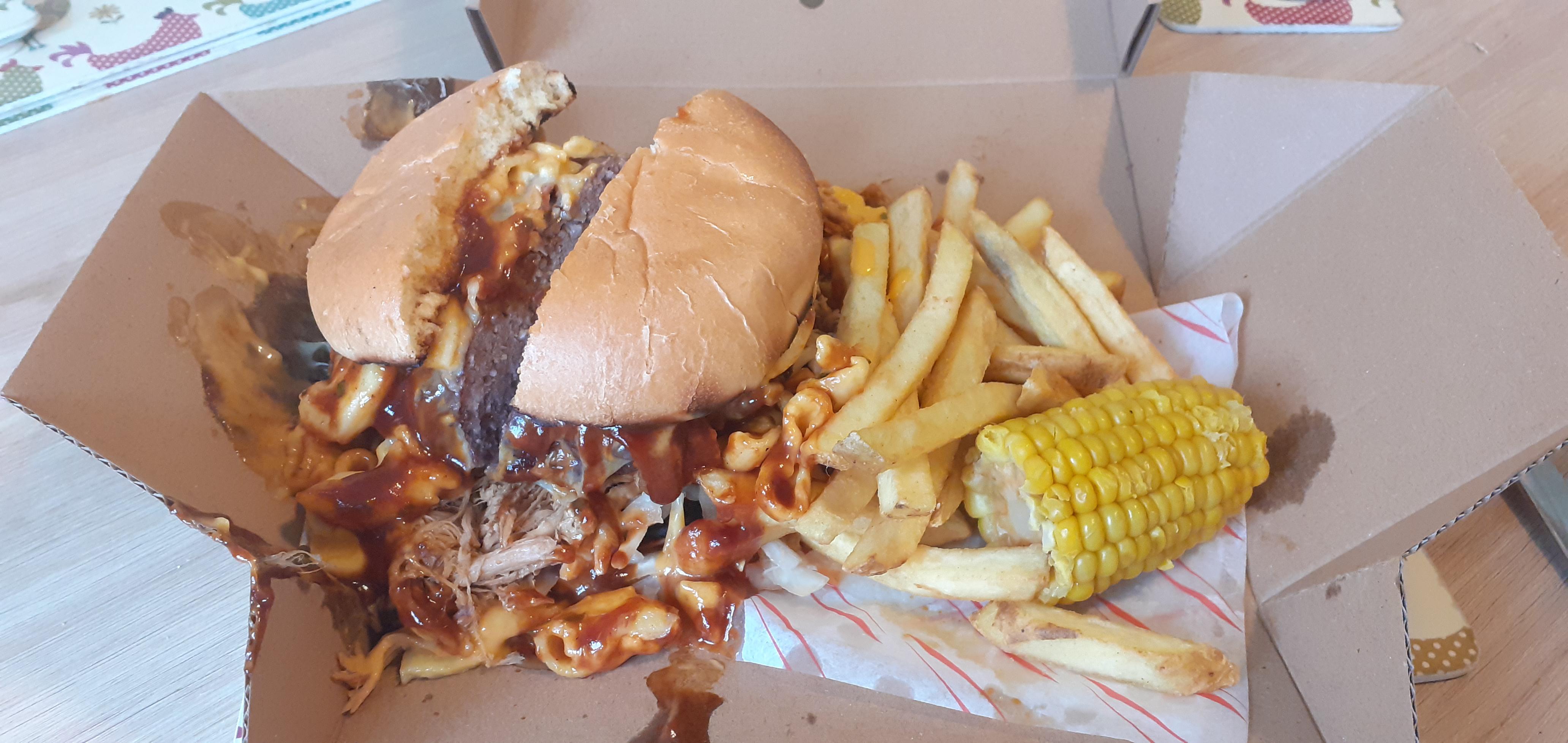 Burger with pulled pork, mac n' cheese, fat slab of meat, corn on the cob e.t.c. | Scrolller