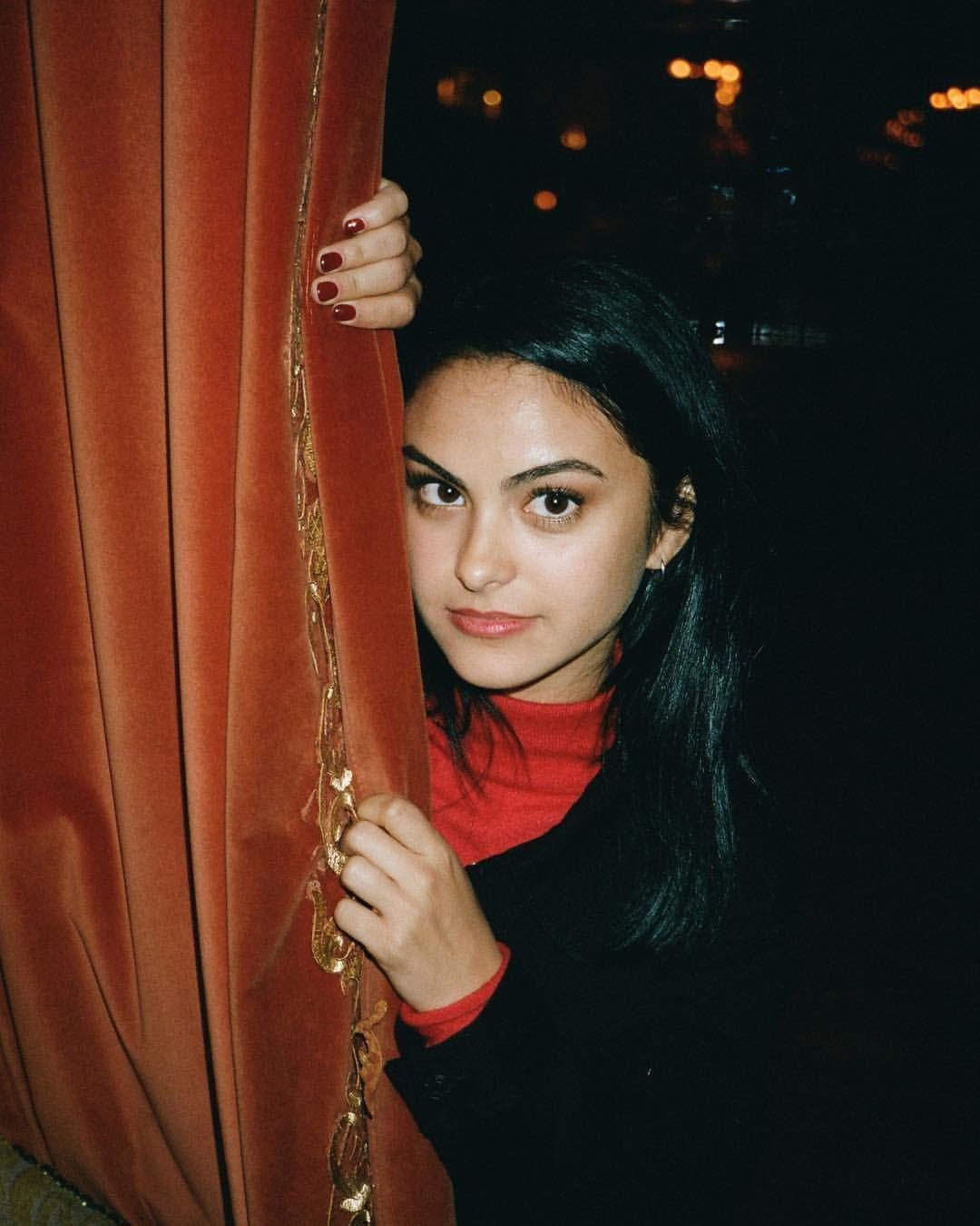 Camila Mendes peeking out of the curtains | Scrolller