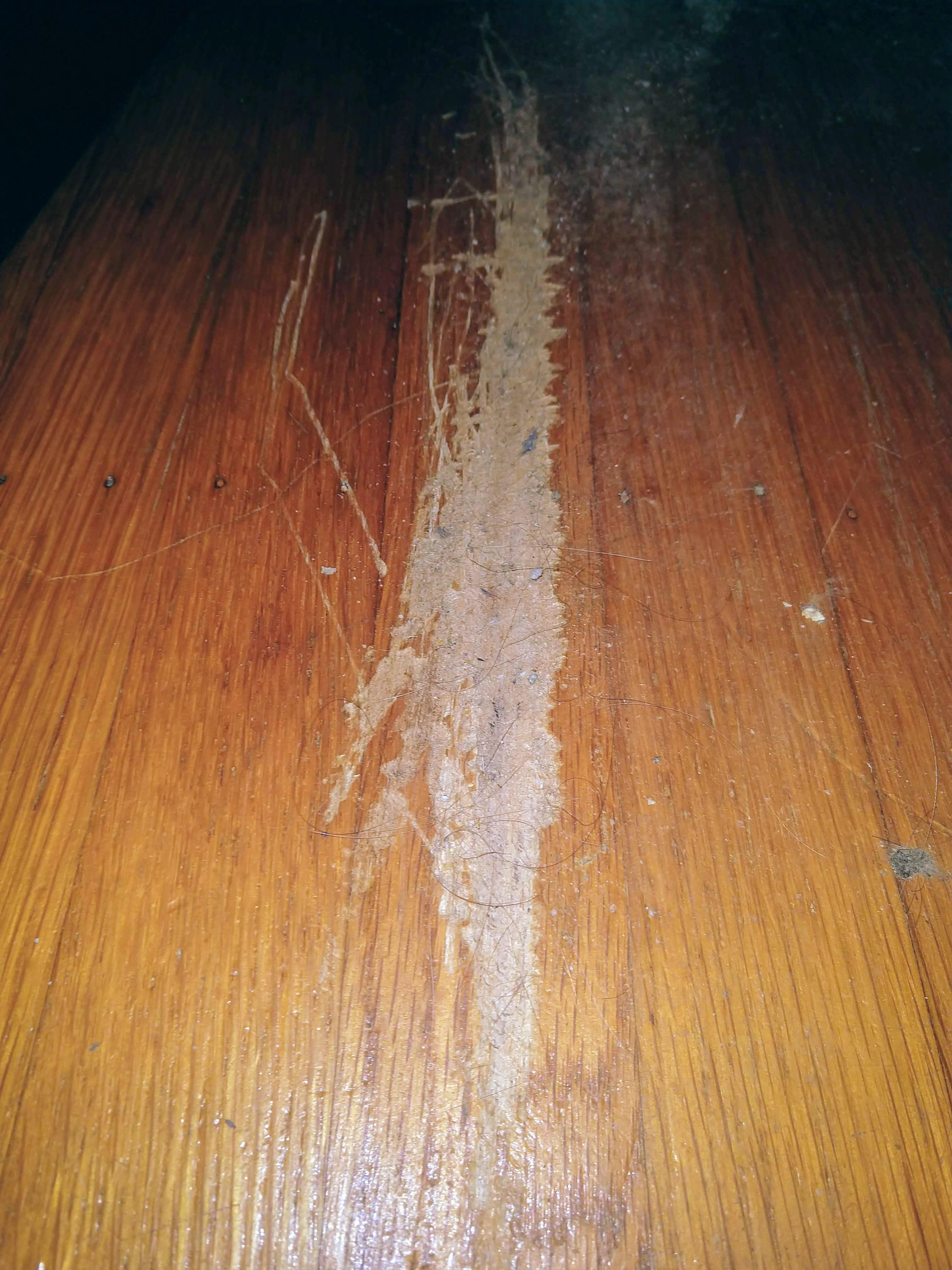 Can I fix the damage to this wooden floor with putty and wood stain? | Scrolller