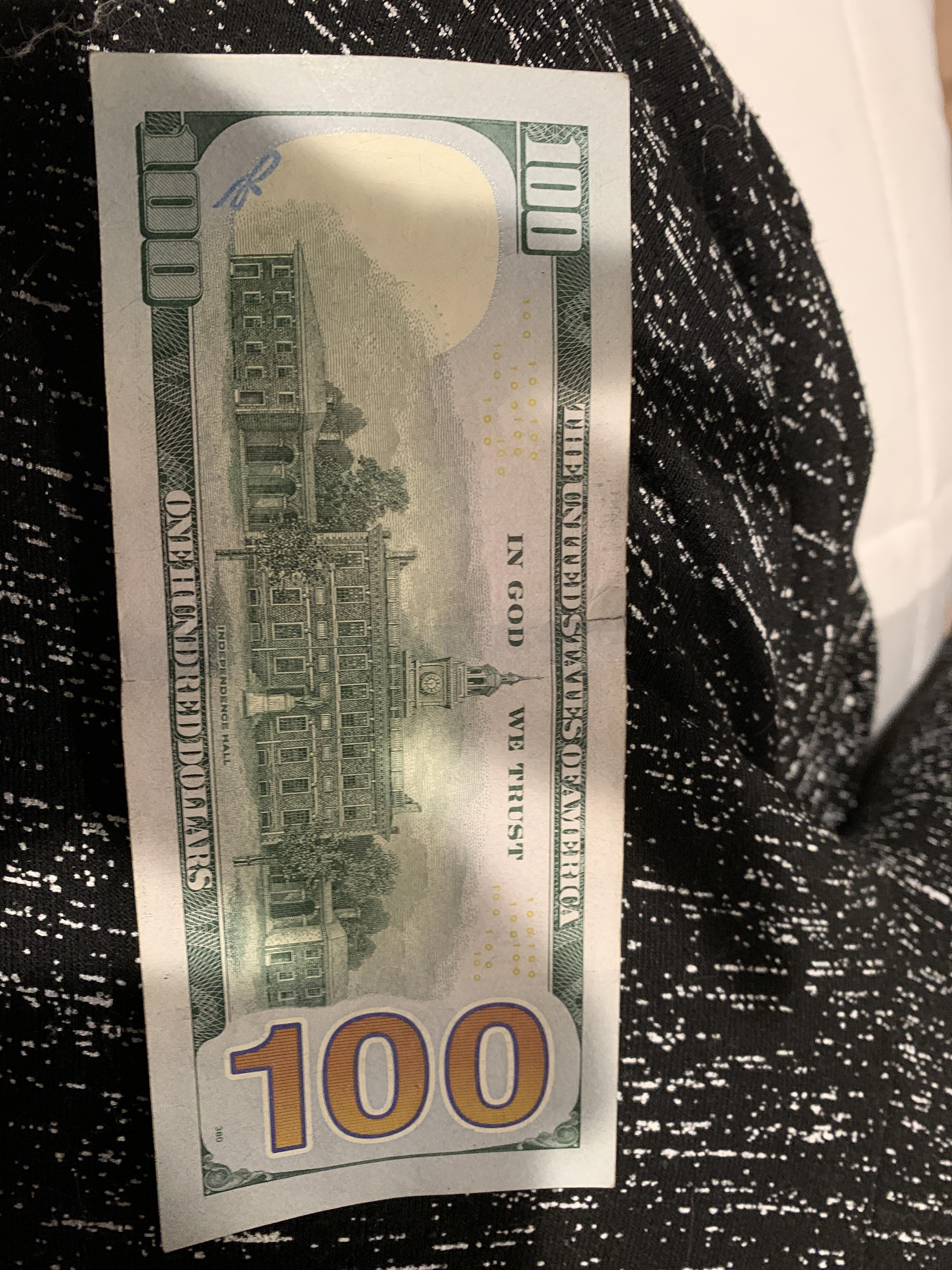 Does Anyone know what the ribbon is in the Lower left-hand corner of this hundred dollar bill ...