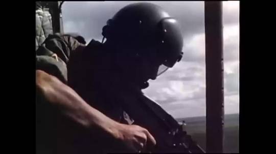 Door gunner on a UH-1 keeps the target covered with an M60 fired from the shoulder | Scrolller