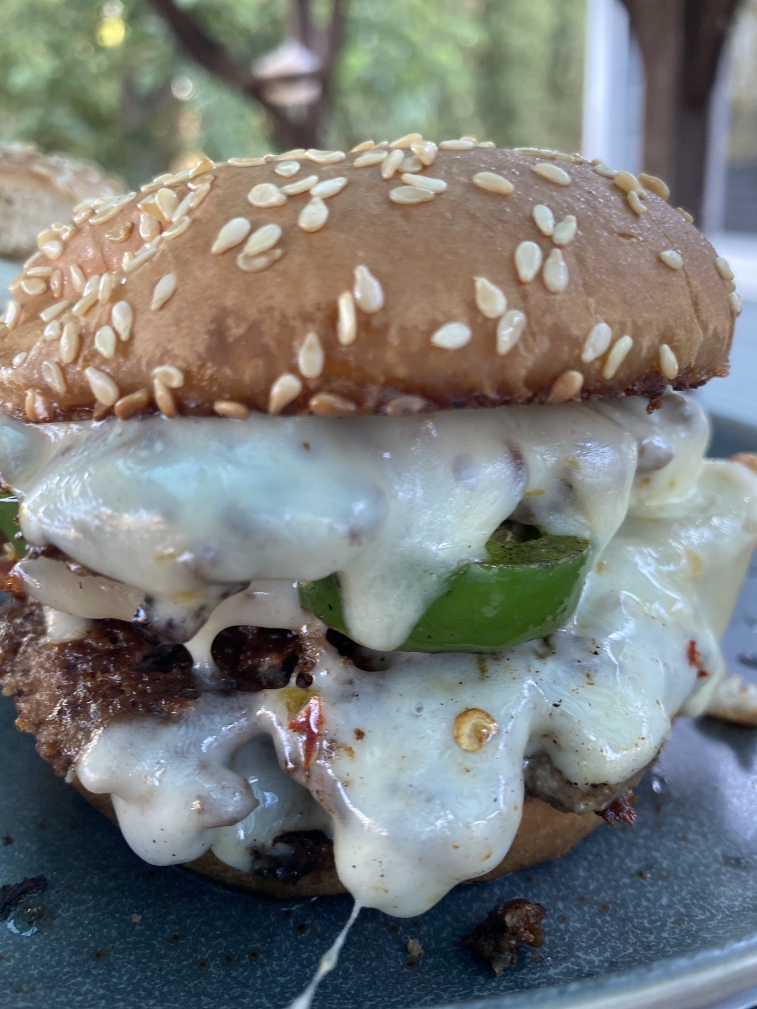 Double smash burger with grilled onions and jalapeños | Scrolller
