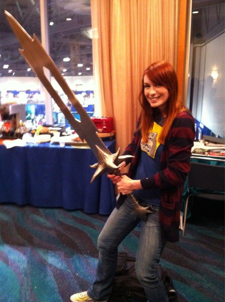 Felicia Day holding a huge Dragon Age sword at Long Beach Comicon | Scrolller