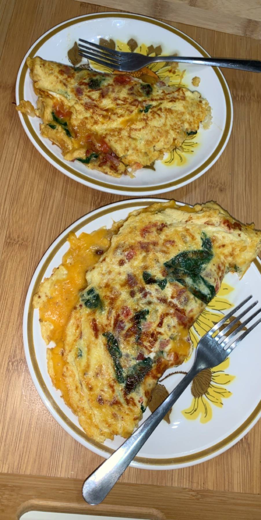 First time making omelets! Spinach, cherry tomatoes, onion, bacon, and cheese. | Scrolller