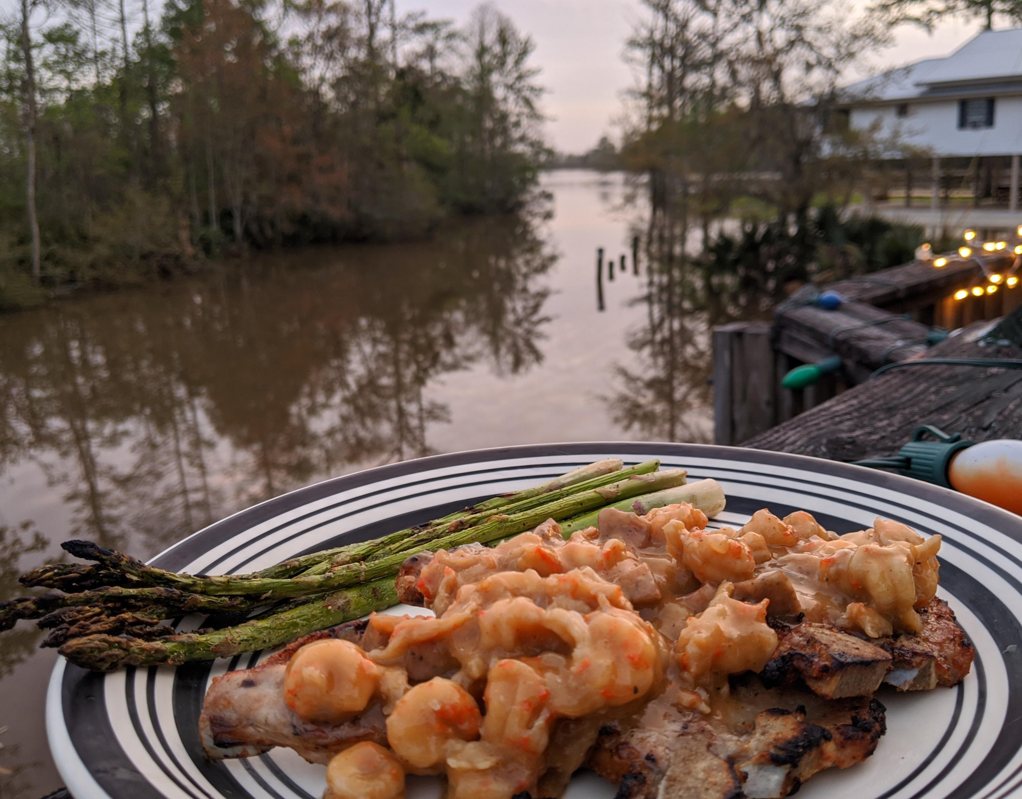 Grilled pork chop with country cajun creole conecuh crawfish creme sauce | Scrolller