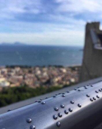 Handrail in Napels Describes the view in braille. | Scrolller