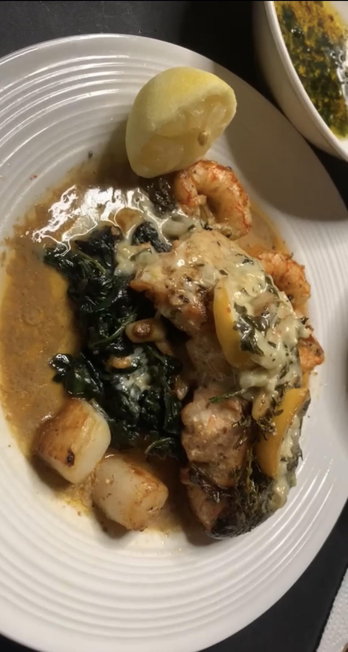 I made a seared lemon garlic salmon over sautéed spinach (the shrimp and scallops wouldn’t stay ...