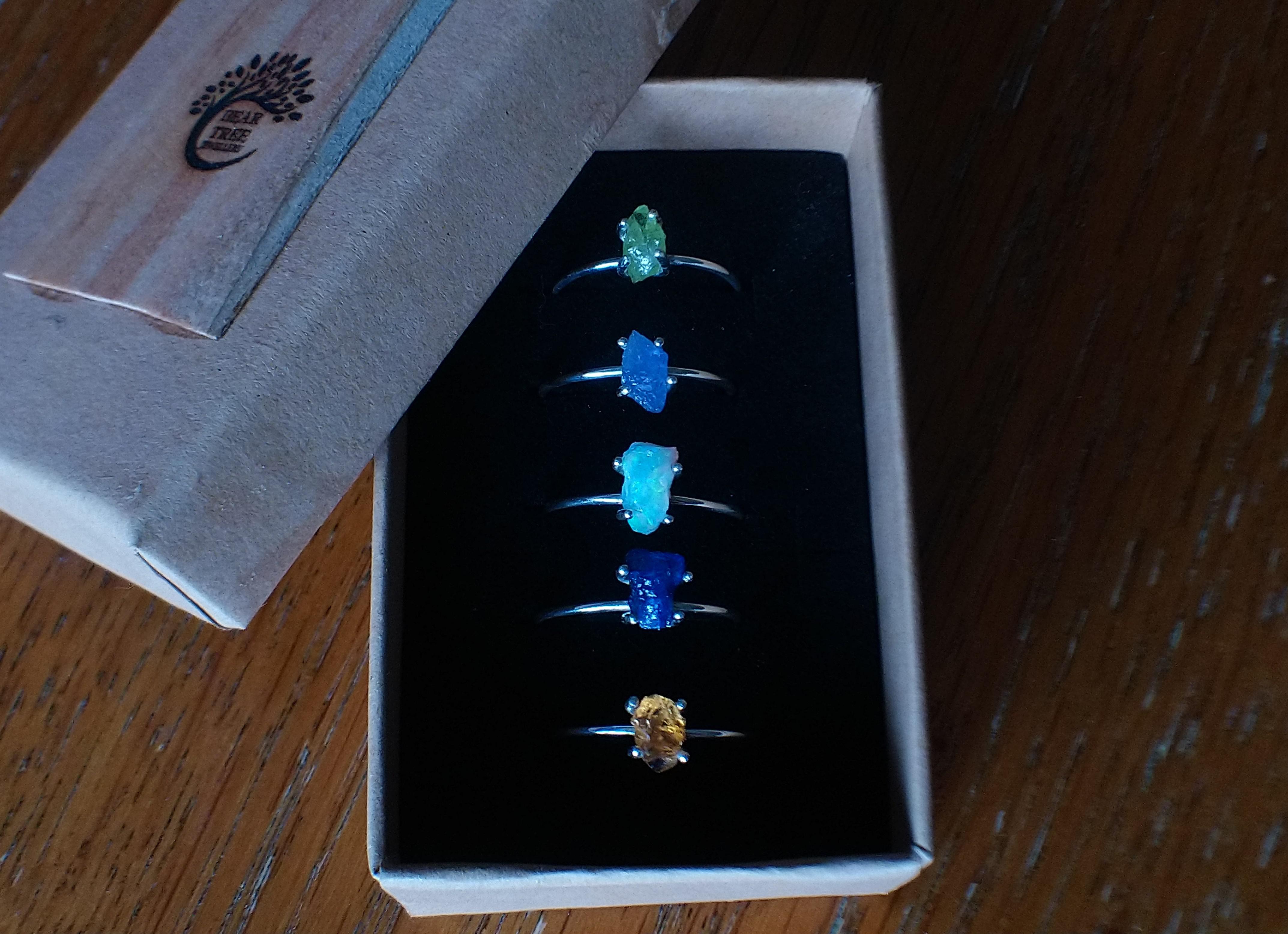 I made these rough stone stacking rings today. Peridot, Tanzanite, Welo Opal, Sapphire and ...