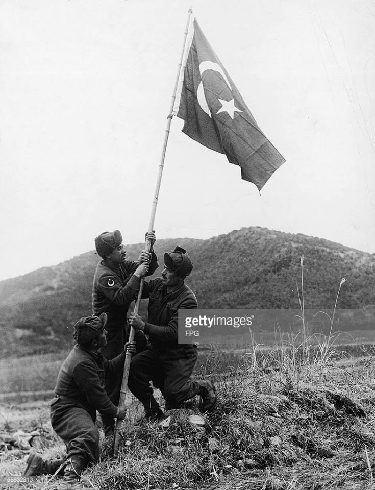 Members of the Turkish Artillery Battalion raising Turkish Flag at a camp site in the 25th ...