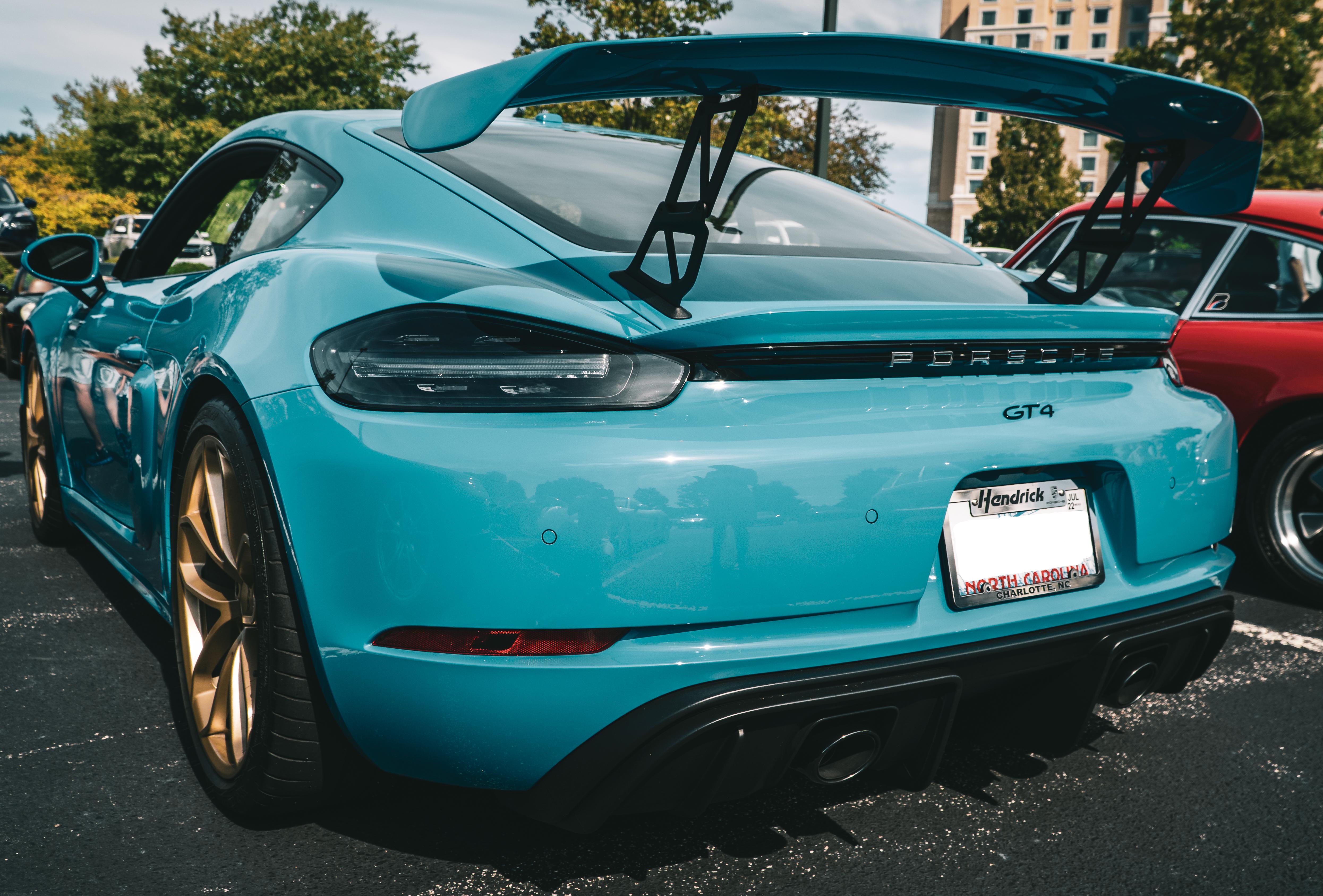 Miami Blue 718 Cayman GT4 with the wing raised | Scrolller